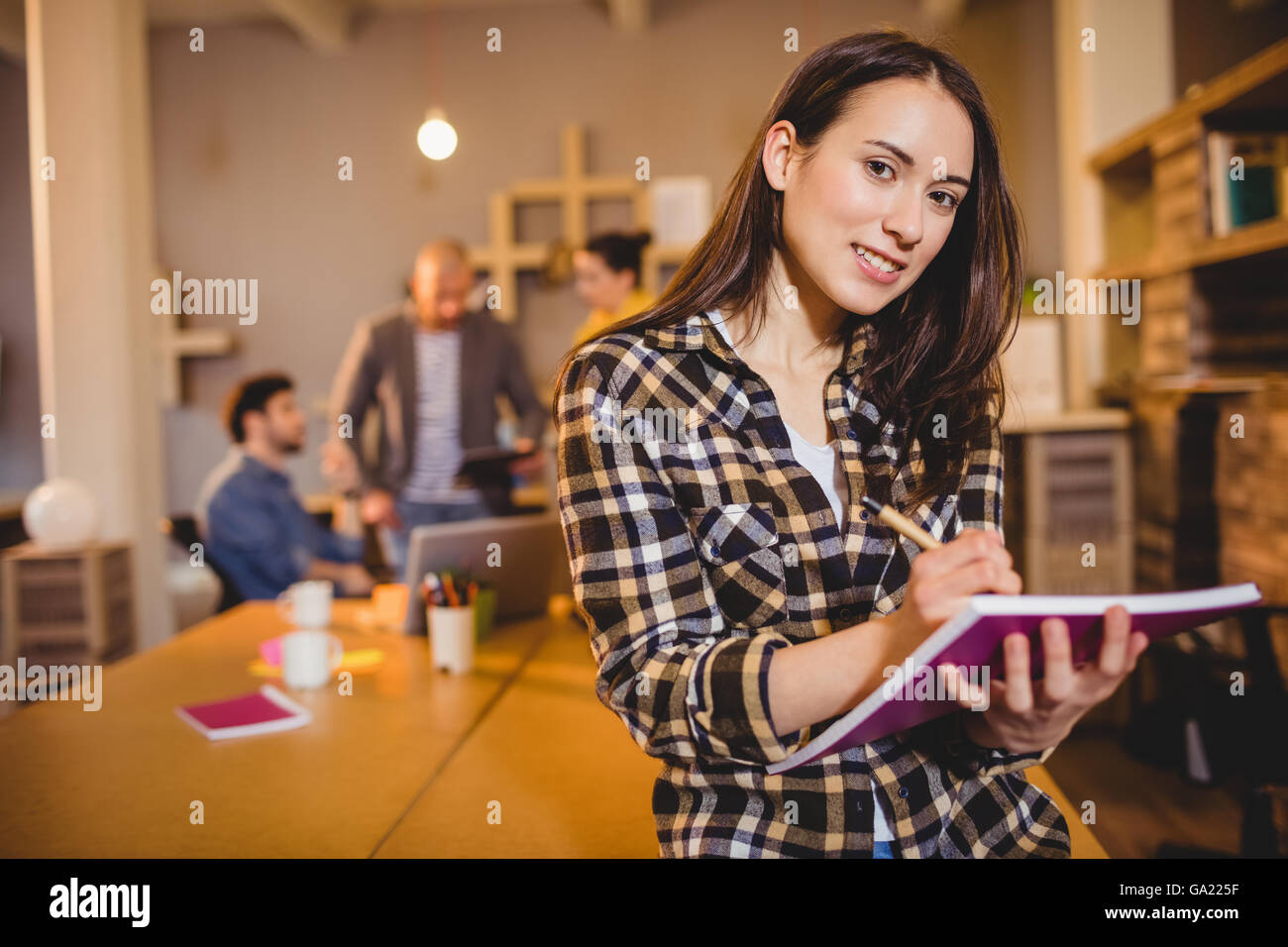 Graphic designer making notes in her diary Stock Photo - Alamy