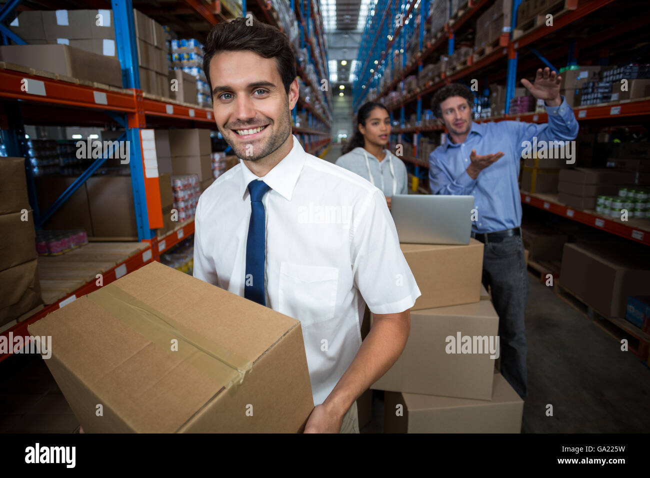 Focus of manager holding cardboard box and smiling Stock Photo - Alamy