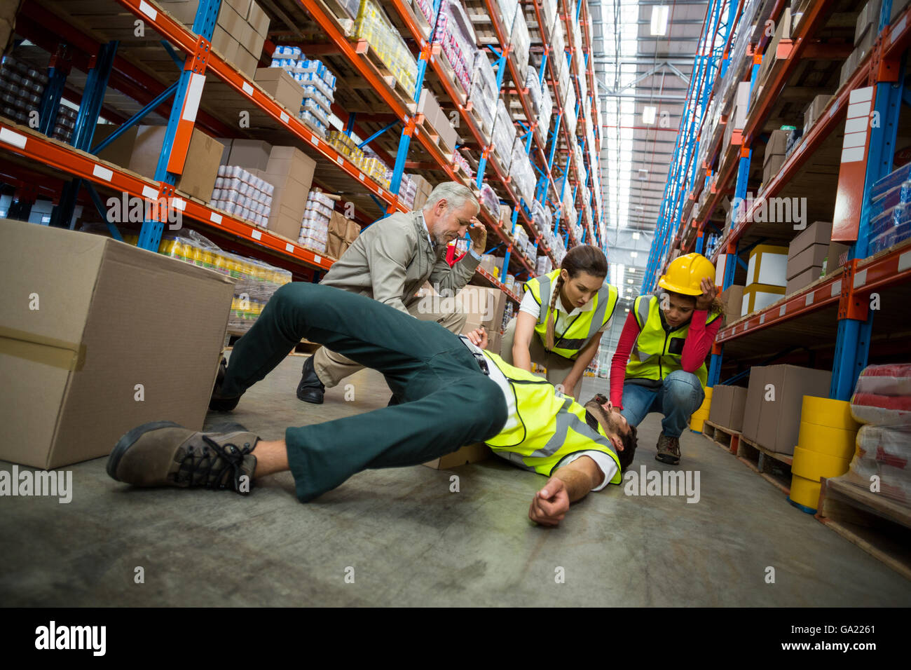 Workers taking care about their colleague lying on the floor Stock ...