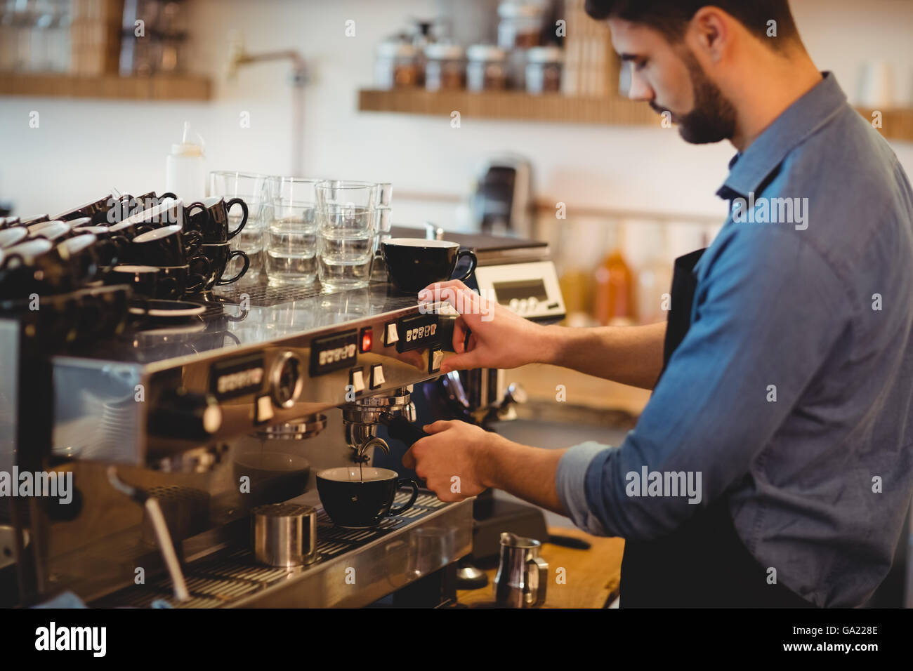 Man taking coffee from espresso machine Stock Photo - Alamy