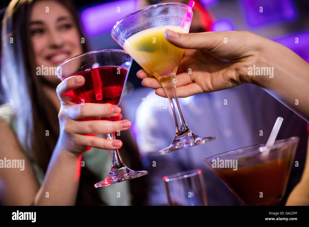 Friends toasting cocktail at bar counter Stock Photo - Alamy