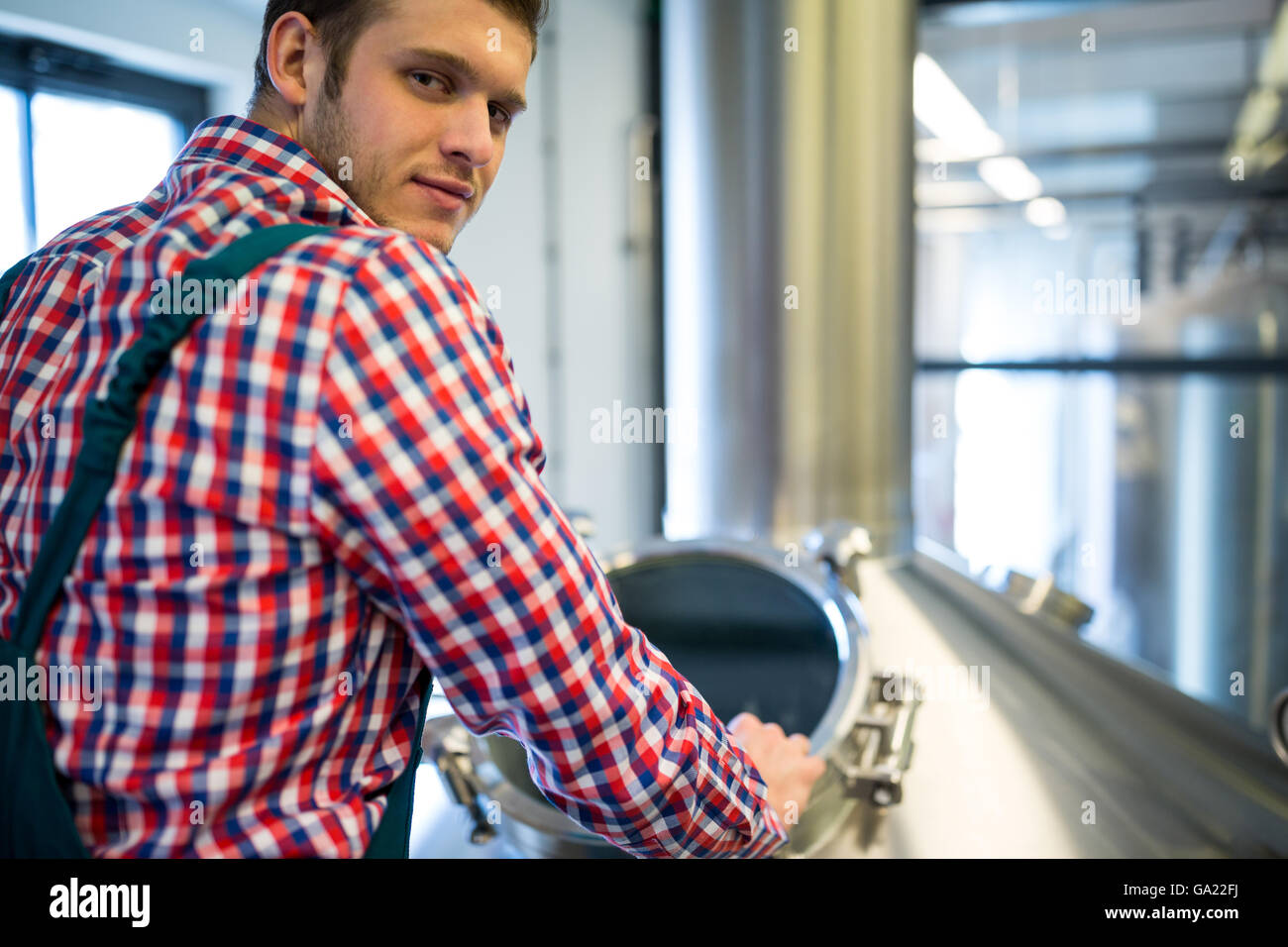 Brewery worker looking steel container hi-res stock photography and ...