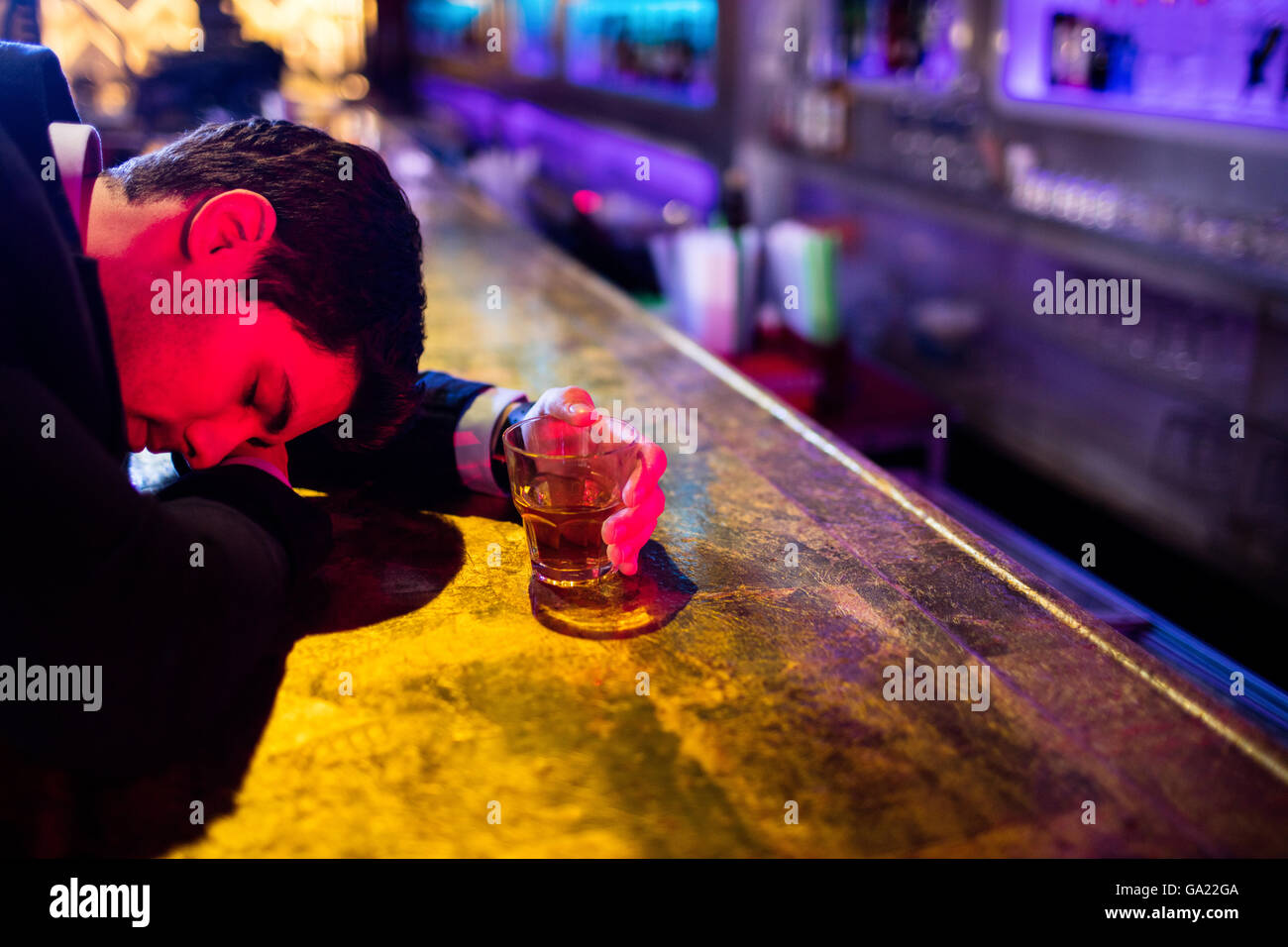 Drunken man sleeping on bar counter Stock Photo - Alamy