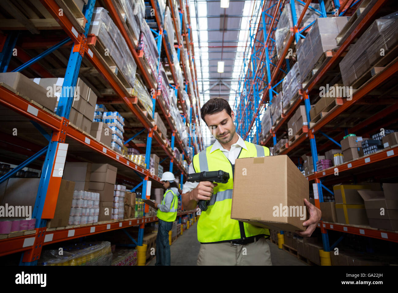 Worker scanning a box Stock Photo - Alamy