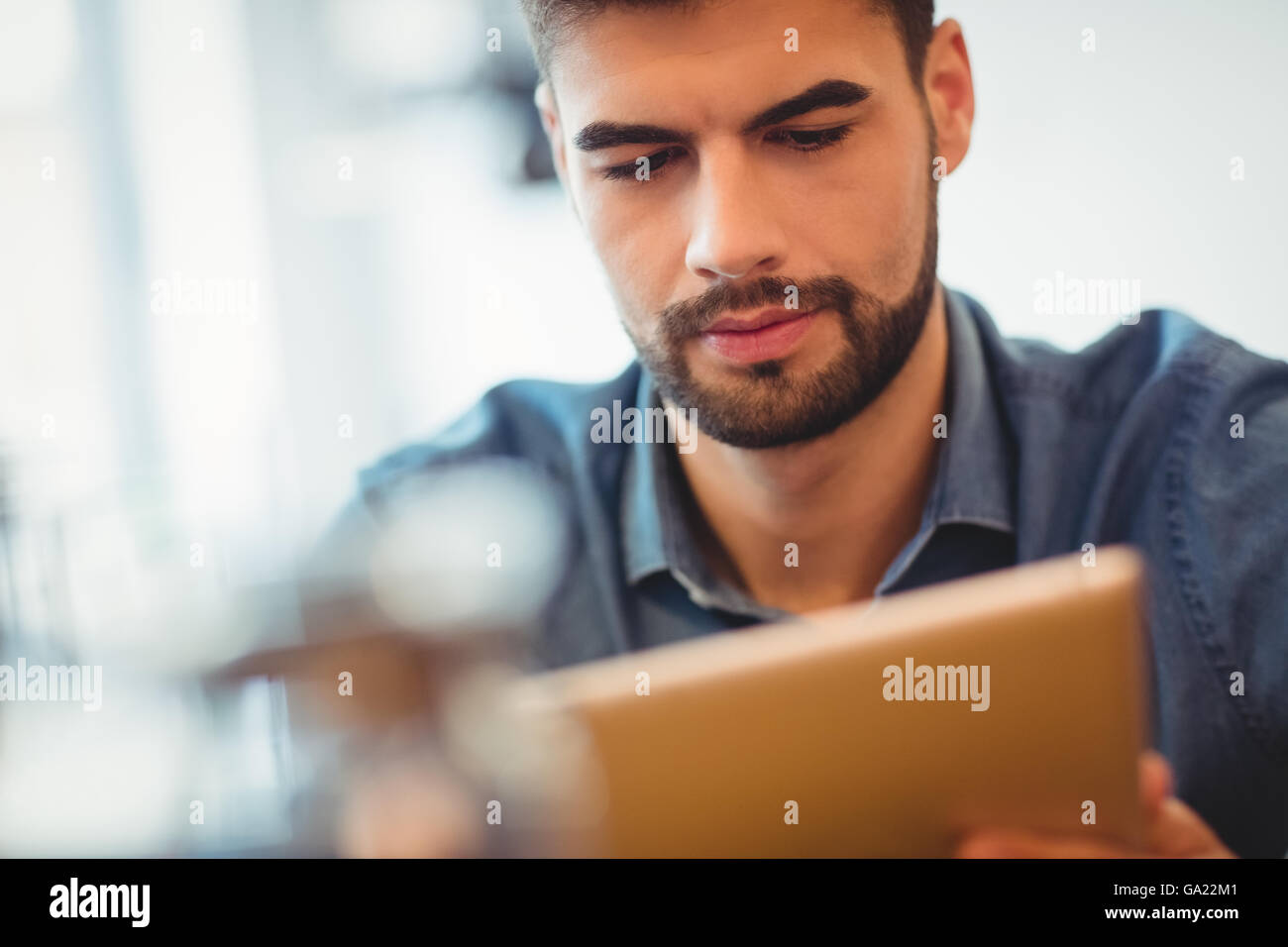 Young man using digital tablet Stock Photo - Alamy