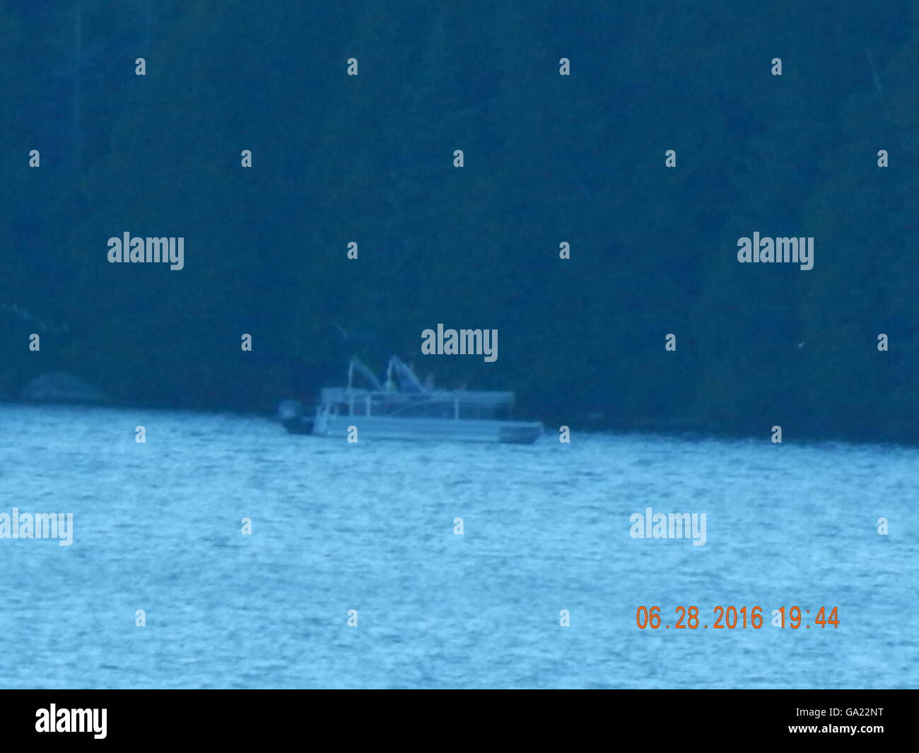 Pontoon boat drifting down a lake Stock Photo - Alamy
