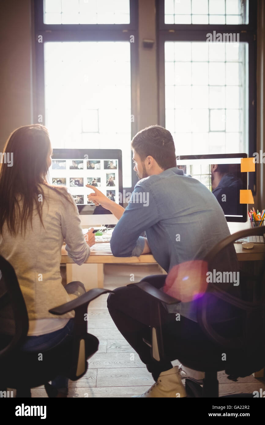 Graphic designers working at desk in the office Stock Photo - Alamy