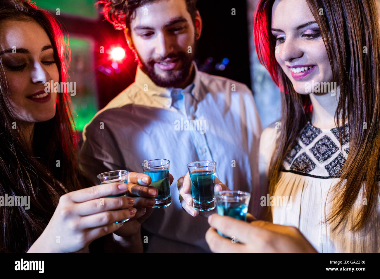 Group of friends toasting tequila shot glasses Stock Photo - Alamy