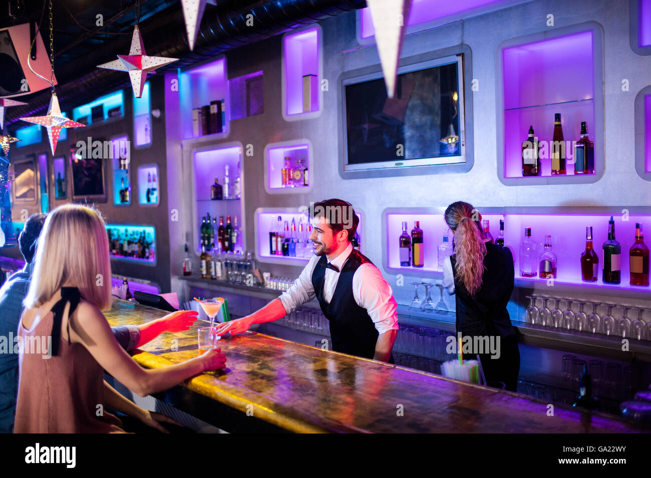 Waiter serving cocktail Stock Photo - Alamy