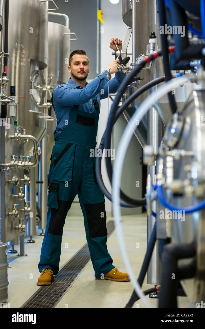 Maintained worker working at brewery Stock Photo - Alamy
