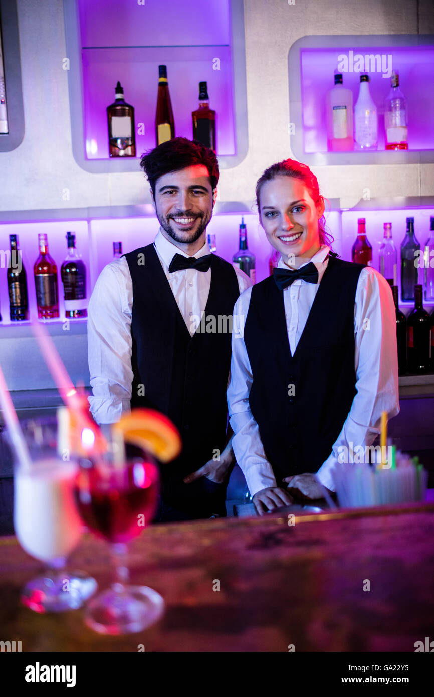 Portrait of waiter and waitress smiling Stock Photo - Alamy