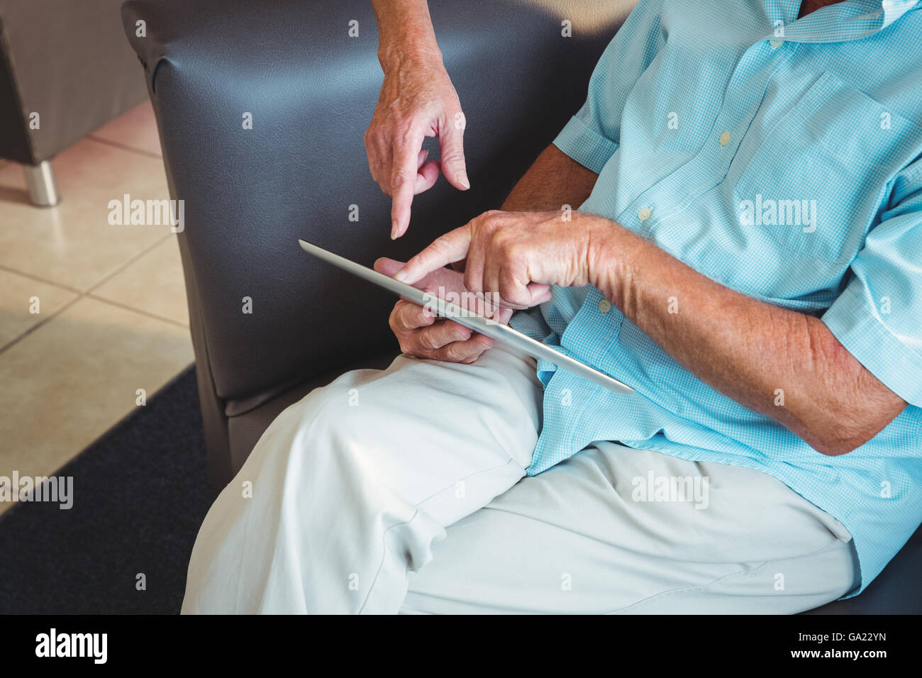 Senior man presenting tablet hi-res stock photography and images - Alamy
