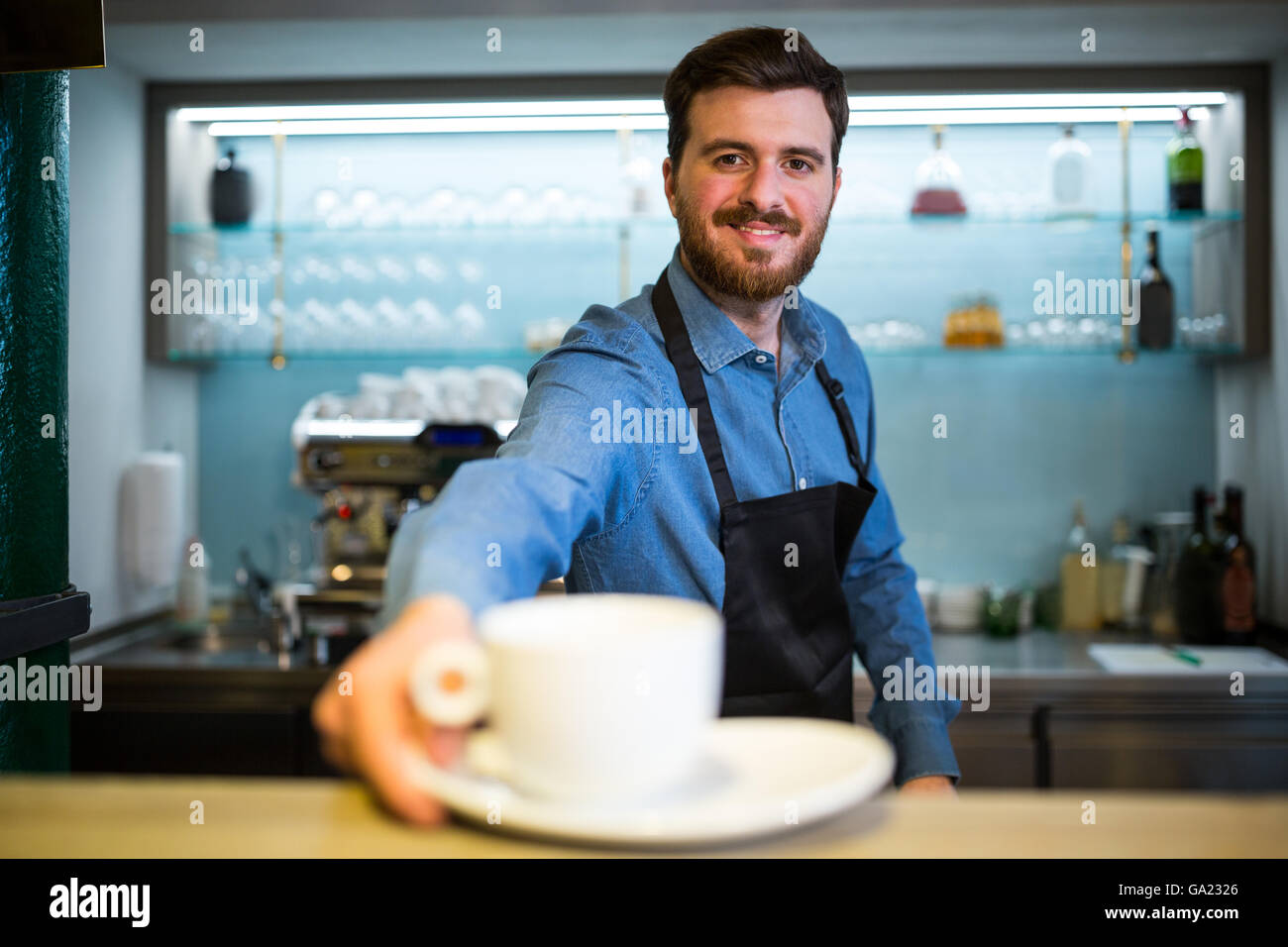 Waiter offering cup of coffee Stock Photo - Alamy