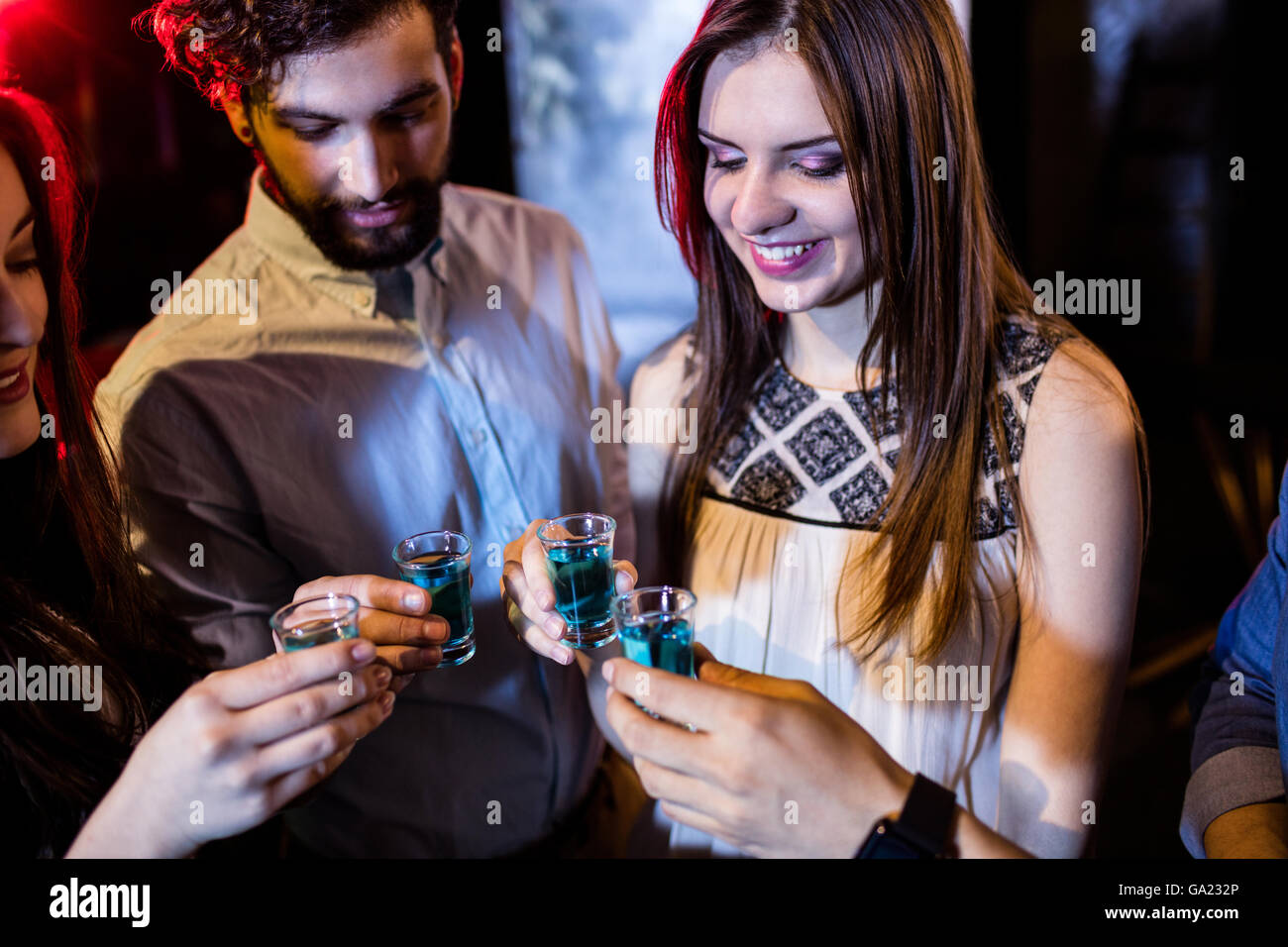 Group of friends toasting tequila shot glasses Stock Photo - Alamy