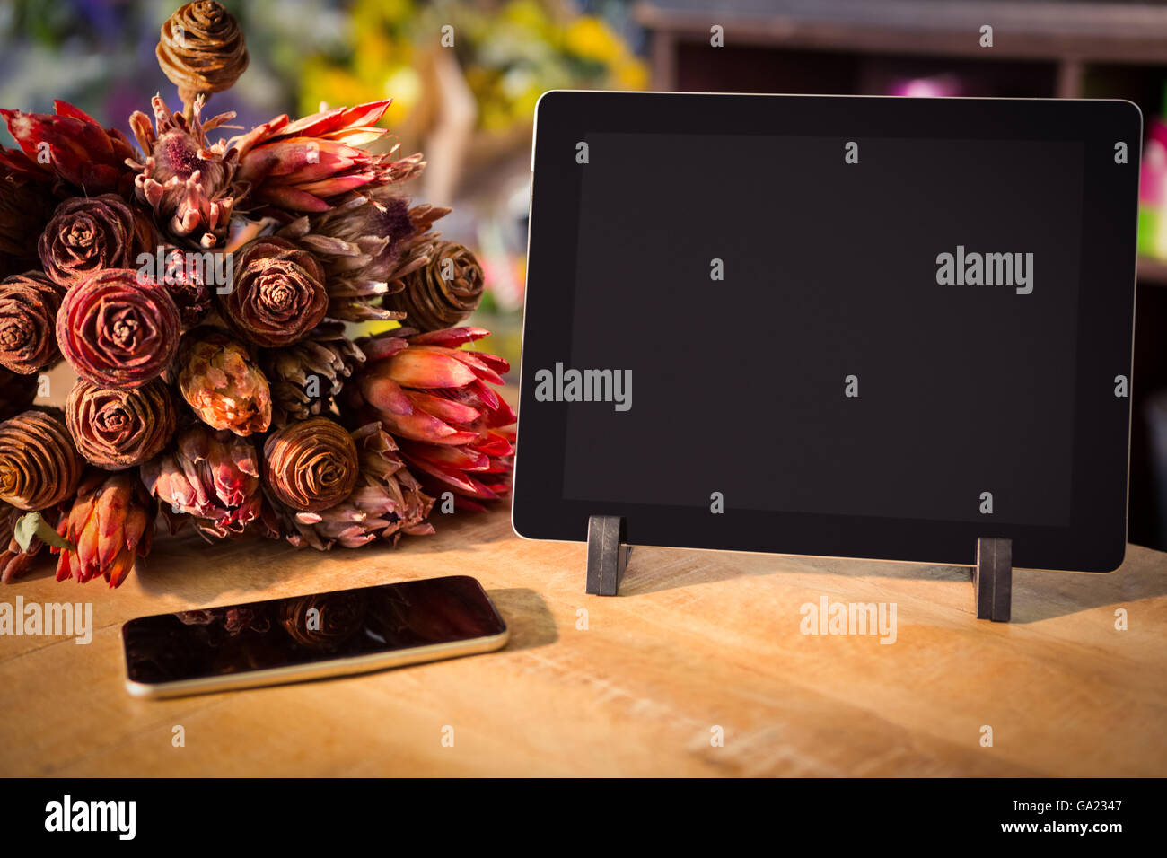 Bouquet of flower with smartphone and digital tablet on the wooden ...