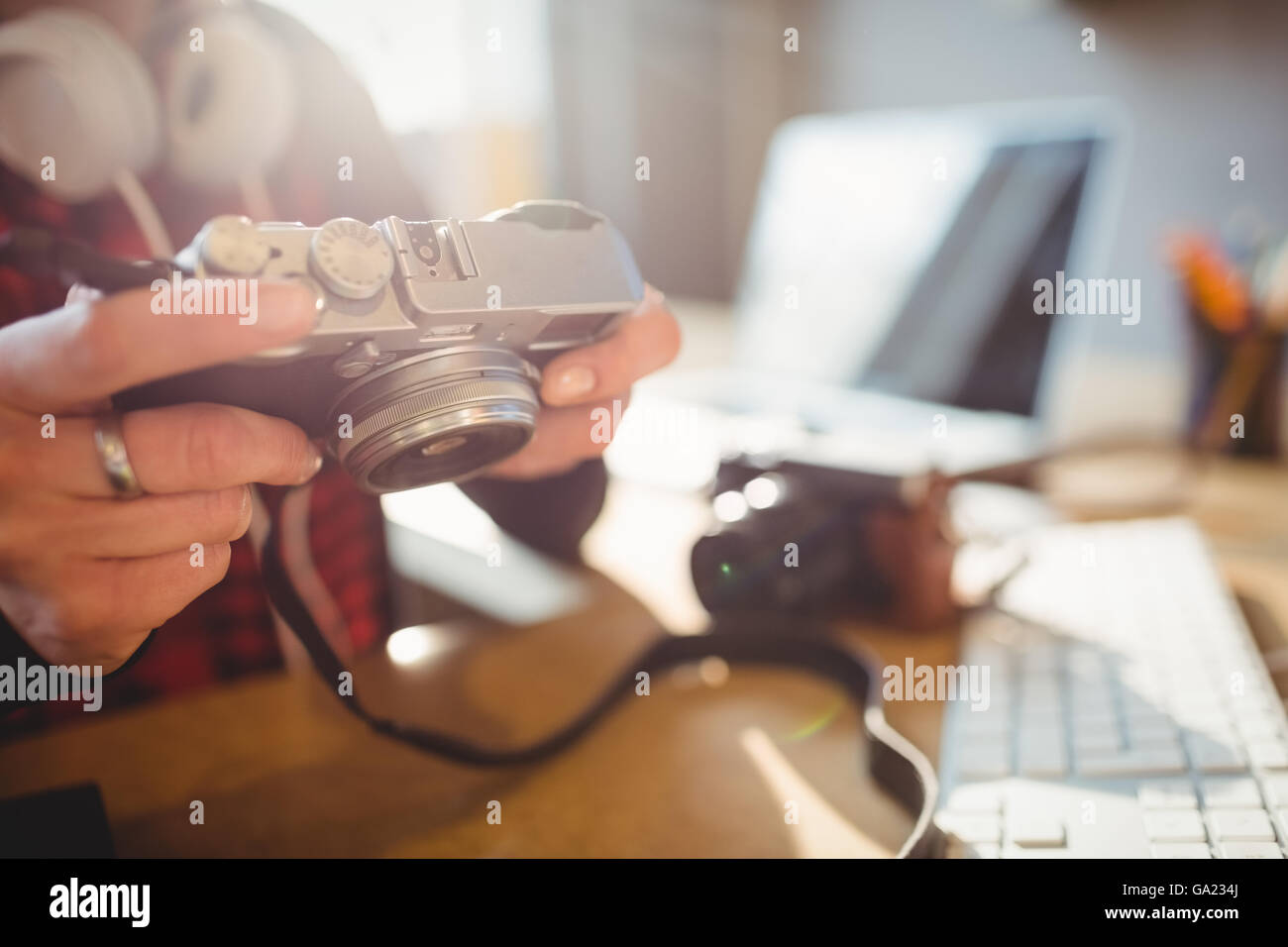 Graphic designer holding digital camera Stock Photo - Alamy