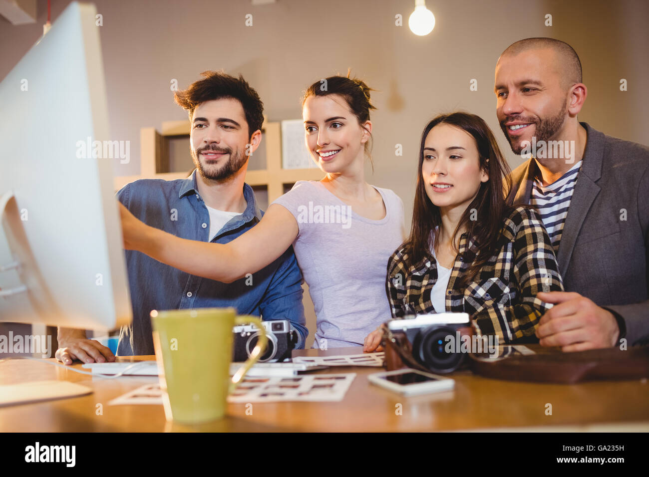 Team of graphic designers working on a computer Stock Photo - Alamy