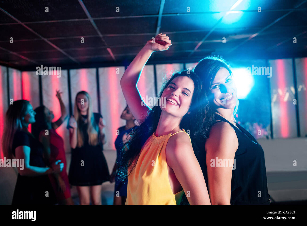 Smiling friends dancing on dance floor Stock Photo - Alamy