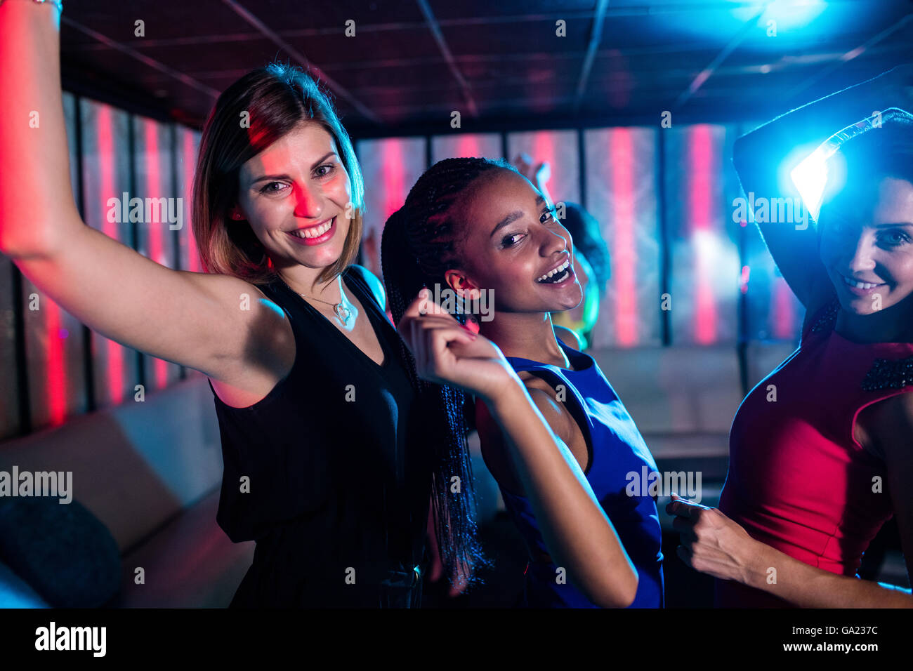 Smiling friends dancing on dance floor Stock Photo - Alamy