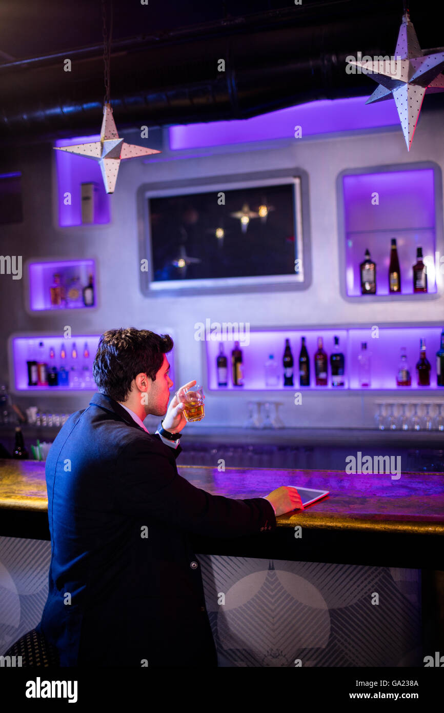 Man having beer at bar counter Stock Photo - Alamy