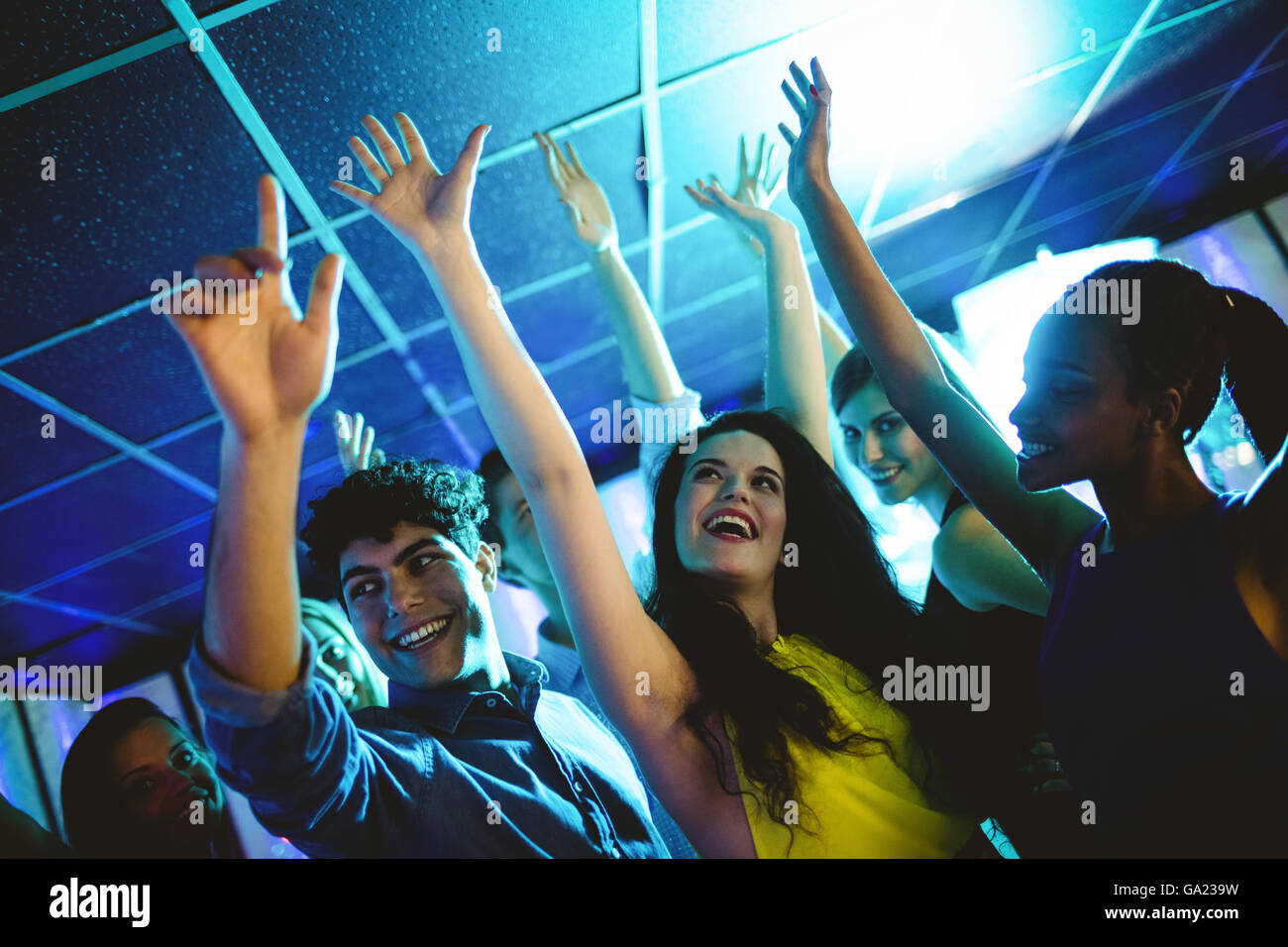 Group of smiling friends dancing on dance floor Stock Photo - Alamy