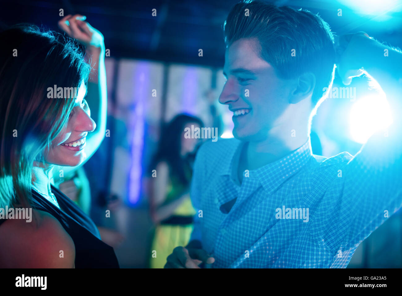 Smiling friends dancing on dance floor Stock Photo - Alamy