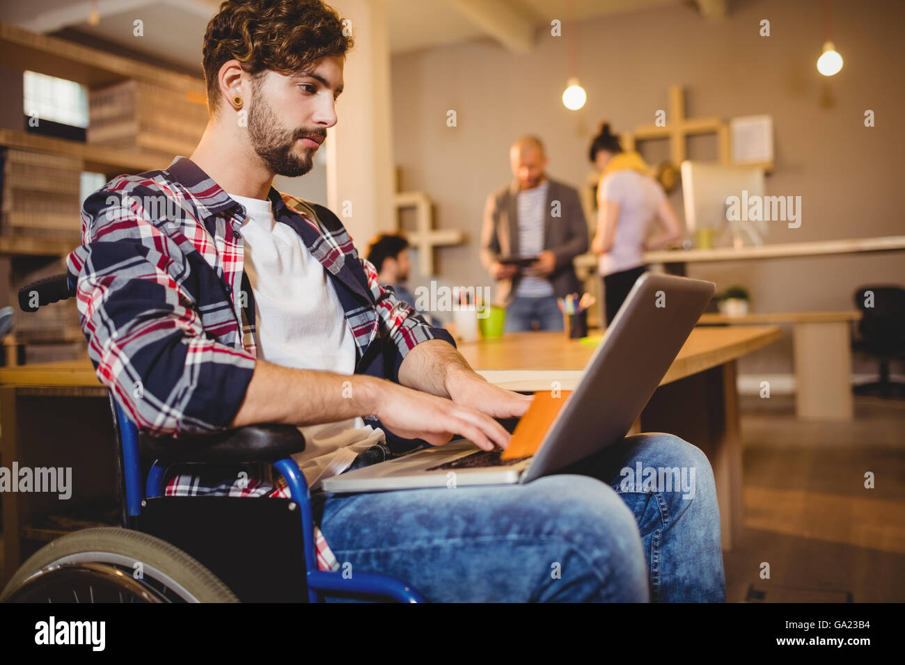 Graphic designer using laptop Stock Photo - Alamy