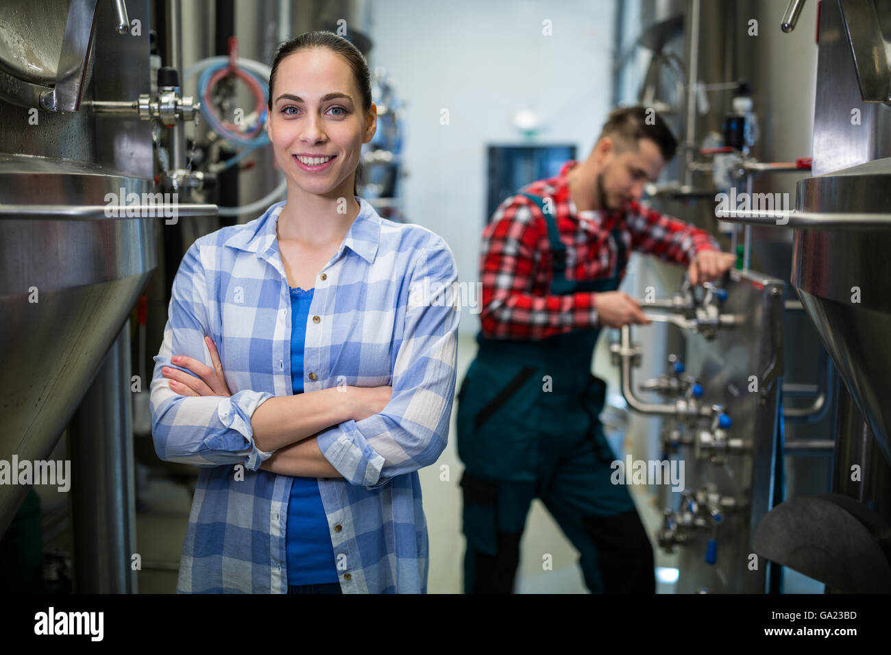 Female maintenance worker standing at brewery Stock Photo - Alamy