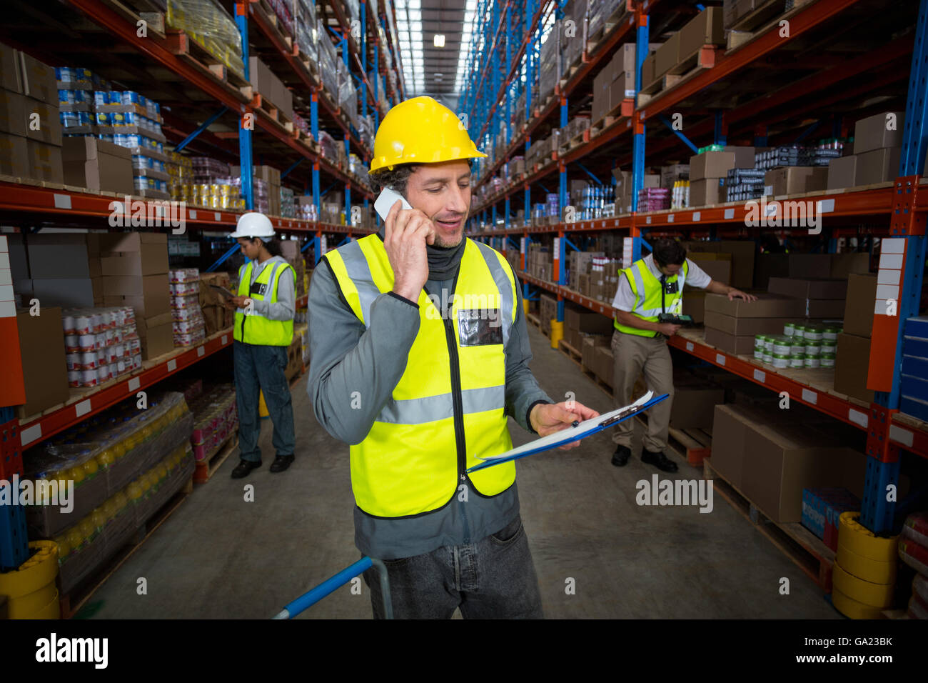 Worker using phone Stock Photo - Alamy