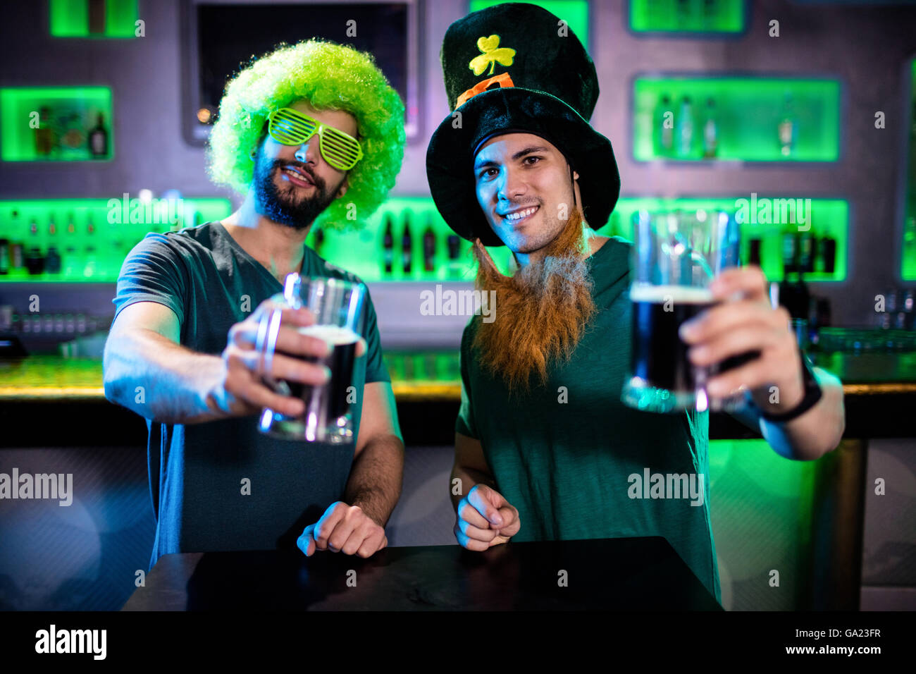 Male friends holding beer mugs Stock Photo - Alamy
