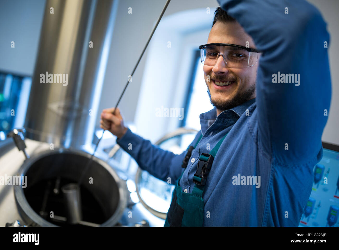 Brewer working at brewery Stock Photo - Alamy