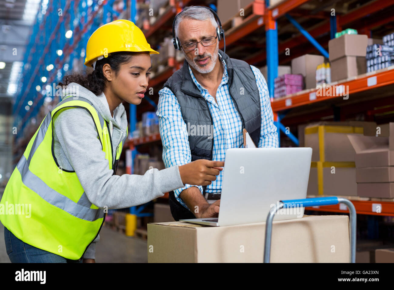 Worker and manager are looking a laptop Stock Photo - Alamy