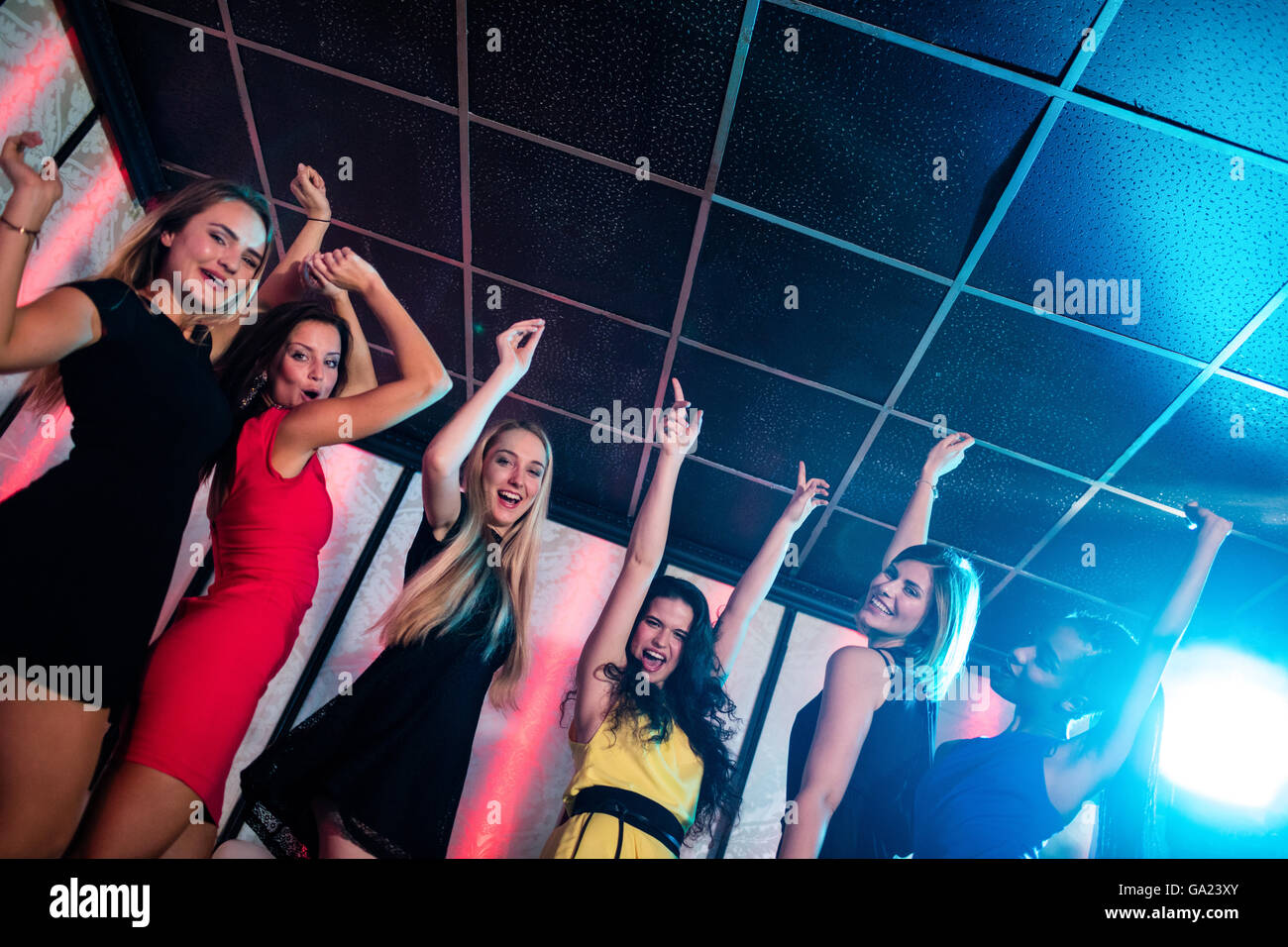 Smiling friends dancing on dance floor Stock Photo - Alamy