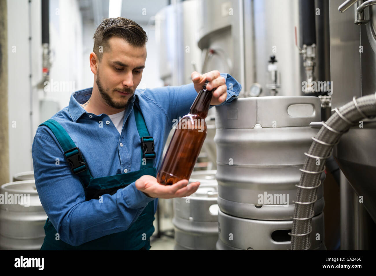 Brewery testing beer bottle Stock Photo - Alamy