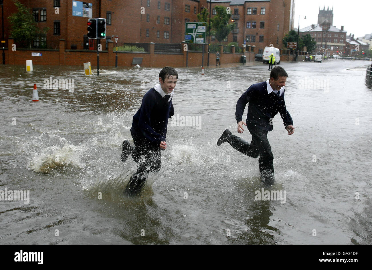 School children run through flood waters after the banks of the River ...