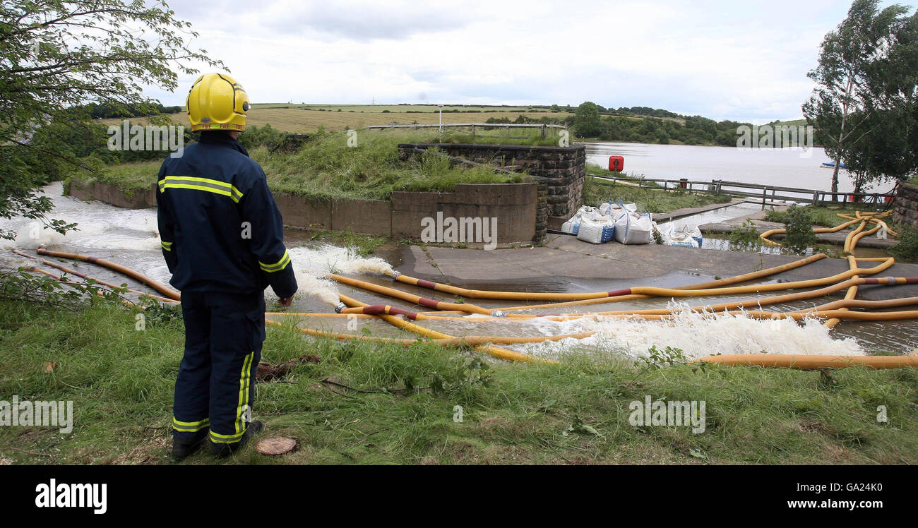 Firefighters walk on top of the Ulley dam near Rotherham, South ...