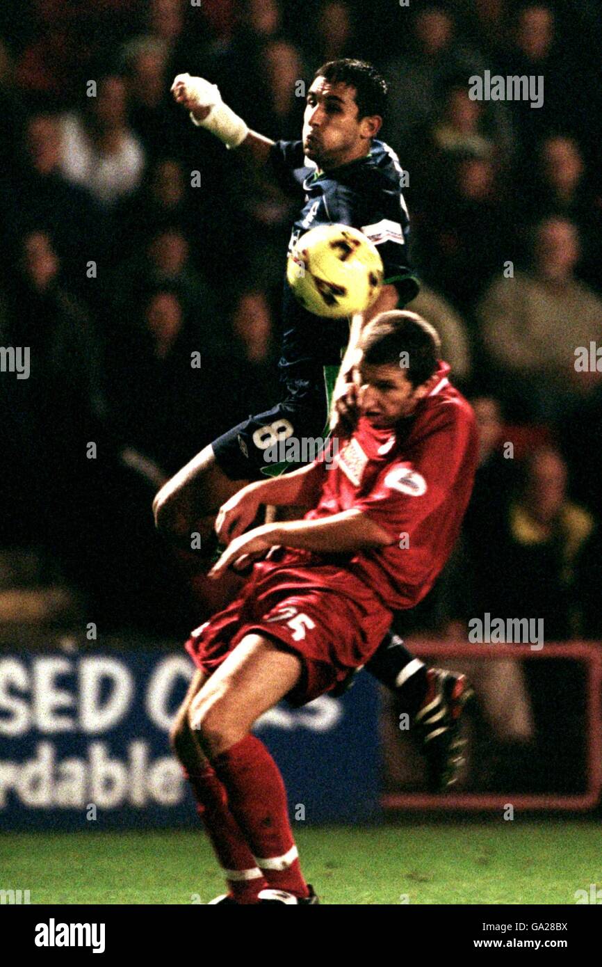 Nottingham Forest's Jack Lester (top) jumps above Walsall's Tony Barras ...