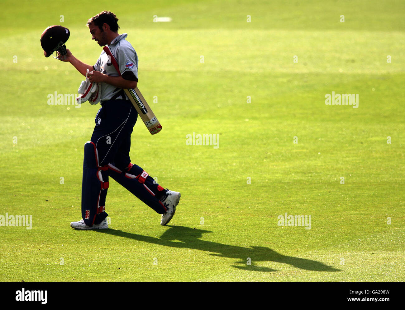 Surrey Brown Caps' James Benning leaves the field after being bowled ...