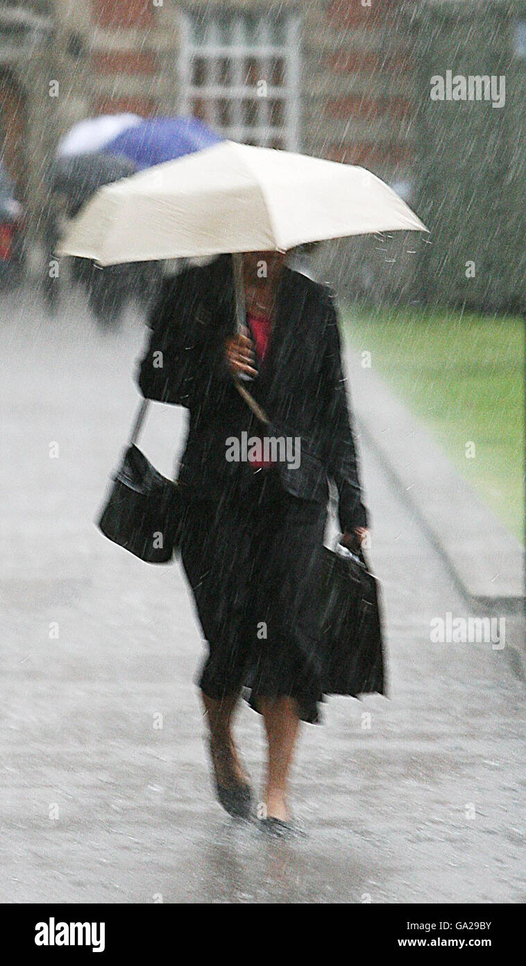 Standalone picture woman making way through heavy rain in westminster ...
