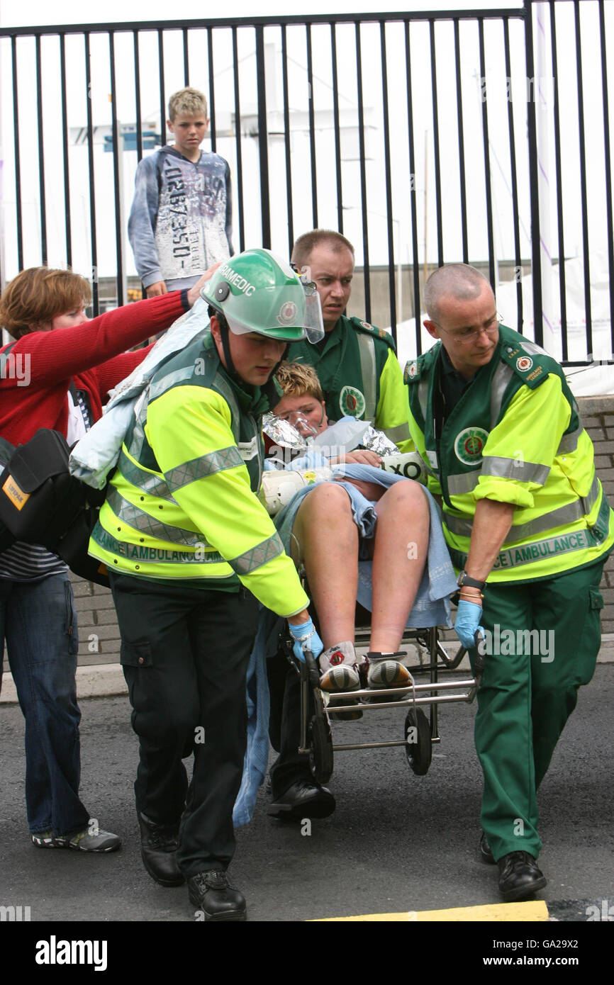 A young boy is treated by paramedics after more than 100 children were ...