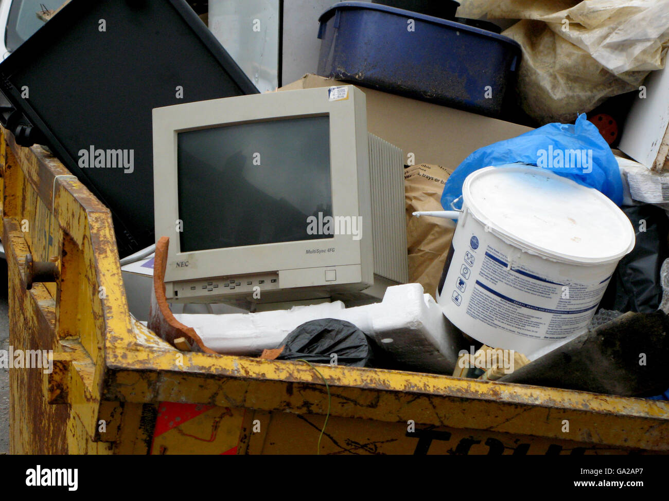 View of ruubish, including a discarded computer monitor, in a skip in ...