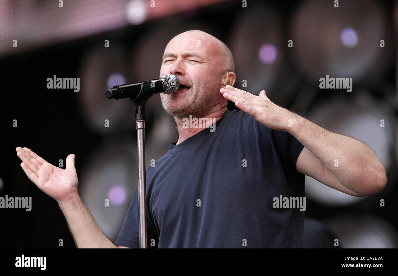 Phil collins on stage genesis performance charity concert wembley ...