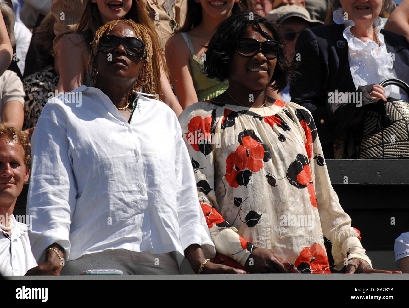 Venus Williams' mother Oracene, left, and sister Serena watch on as ...