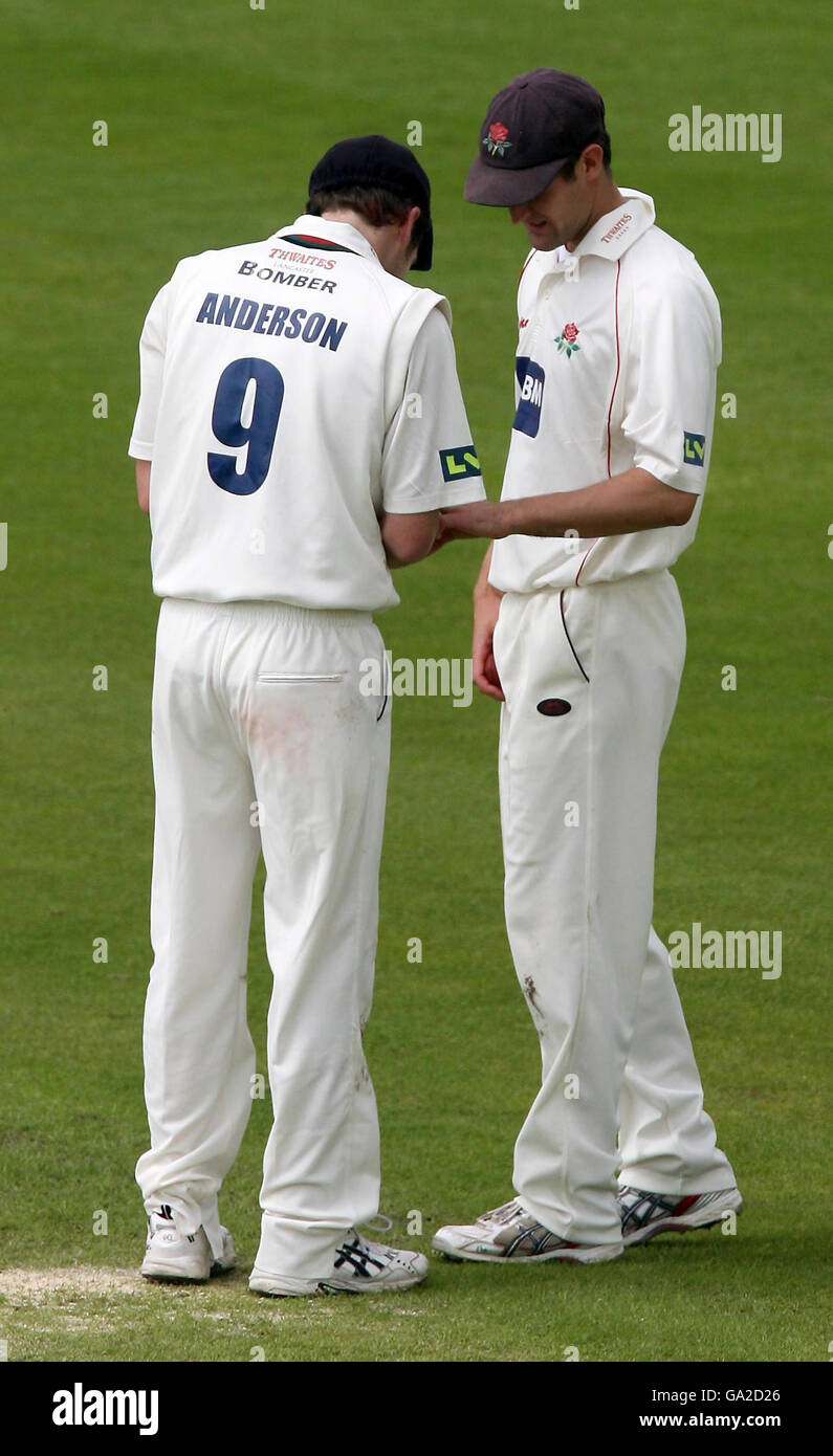 Lancashire's James Anderson shows captain Mark Chilton his injuried arm ...