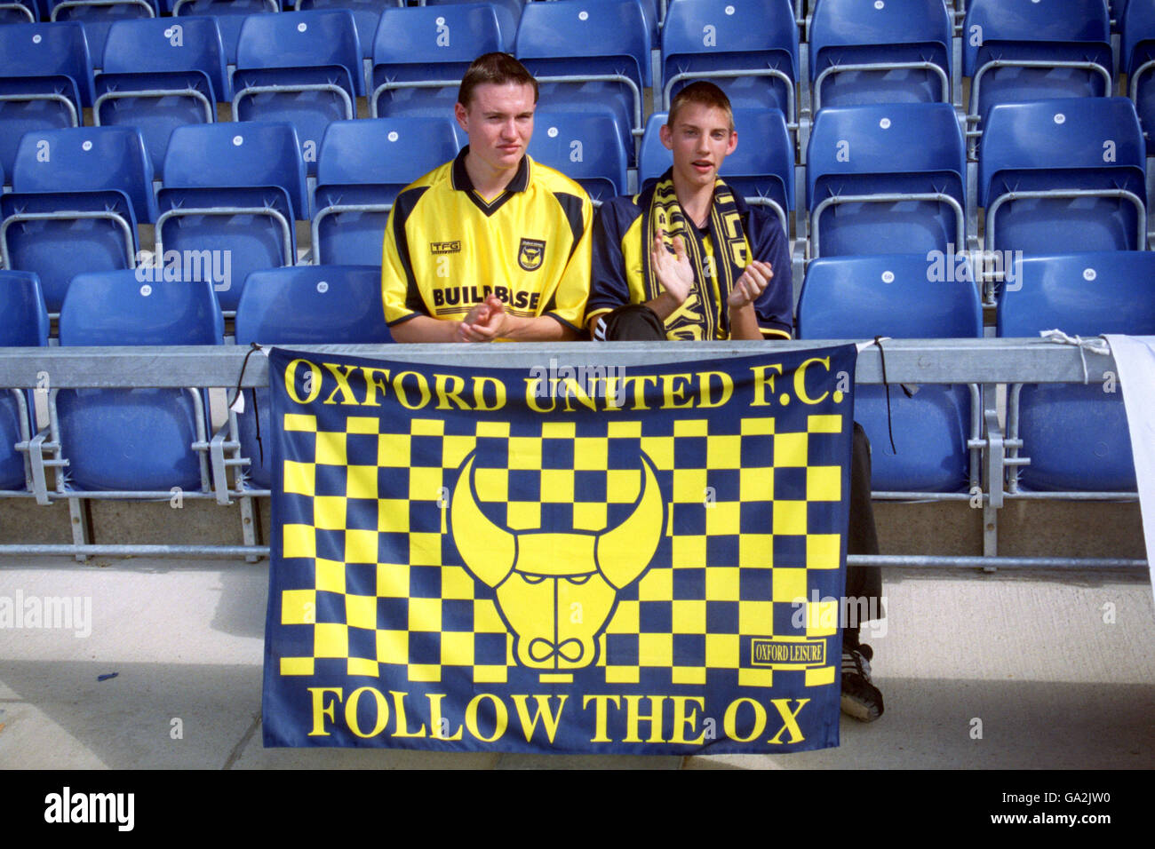 Two oxford united fans with a banner supporting their team hi-res stock ...