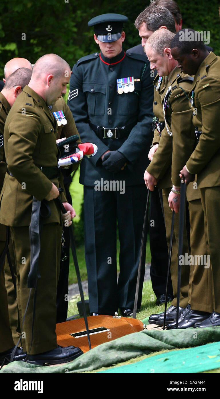 Corporal Will Rigby looks down at the coffin of his indentical twin ...