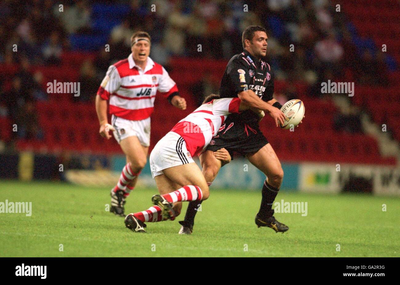 Wigan Warriors' Matthew Johns (l)puts a tackle in on St Helens' Tommy ...