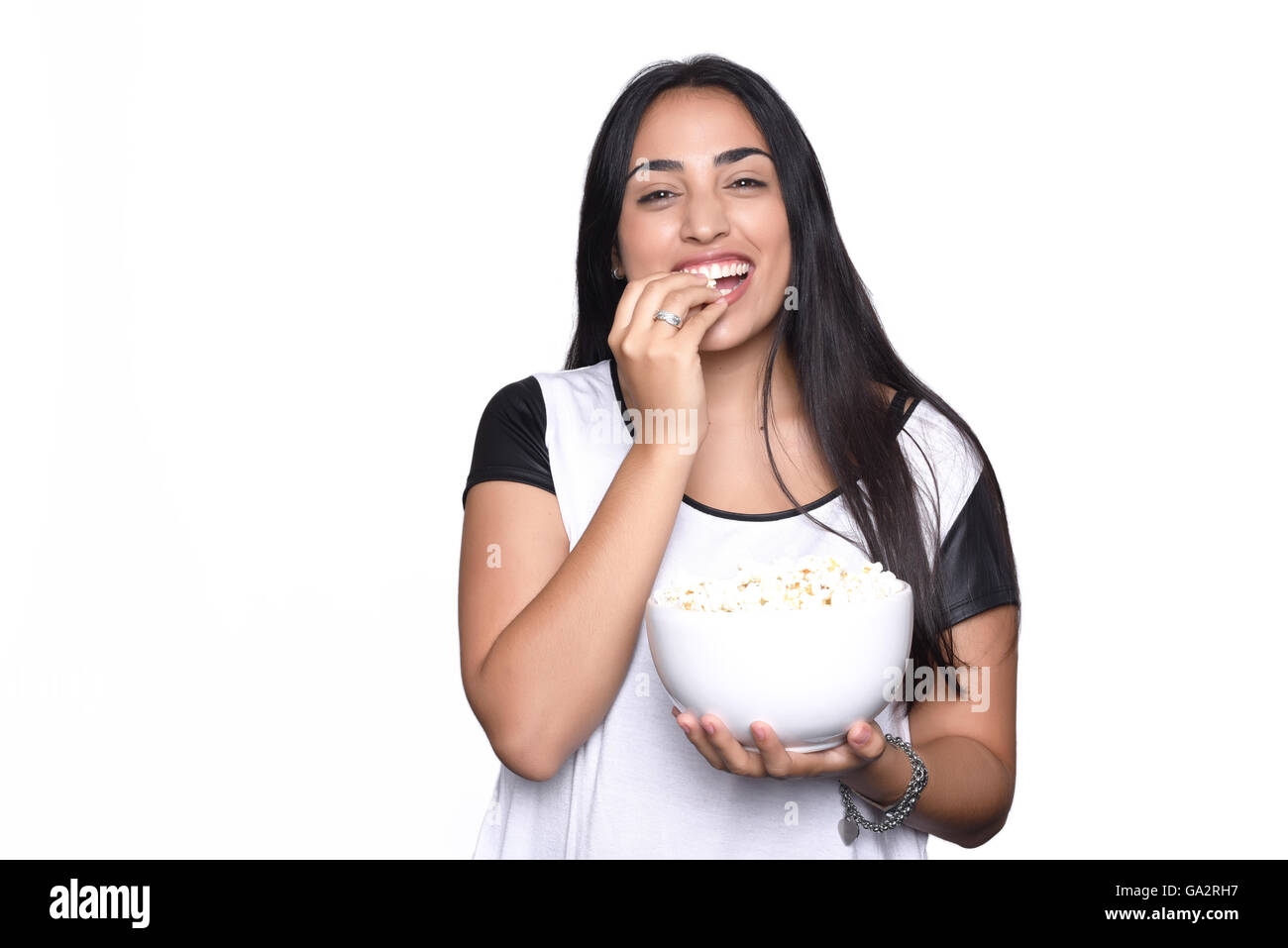 Young beautiful woman eating popcorn. Isolated white background Stock ...