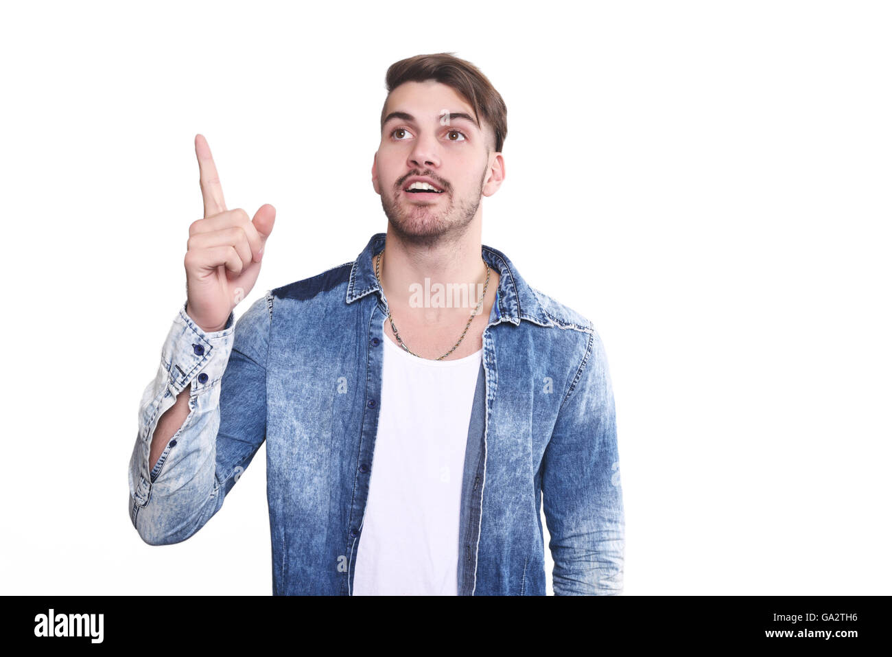 Portrait of attractive young man pointing up surprised. Isolated white ...