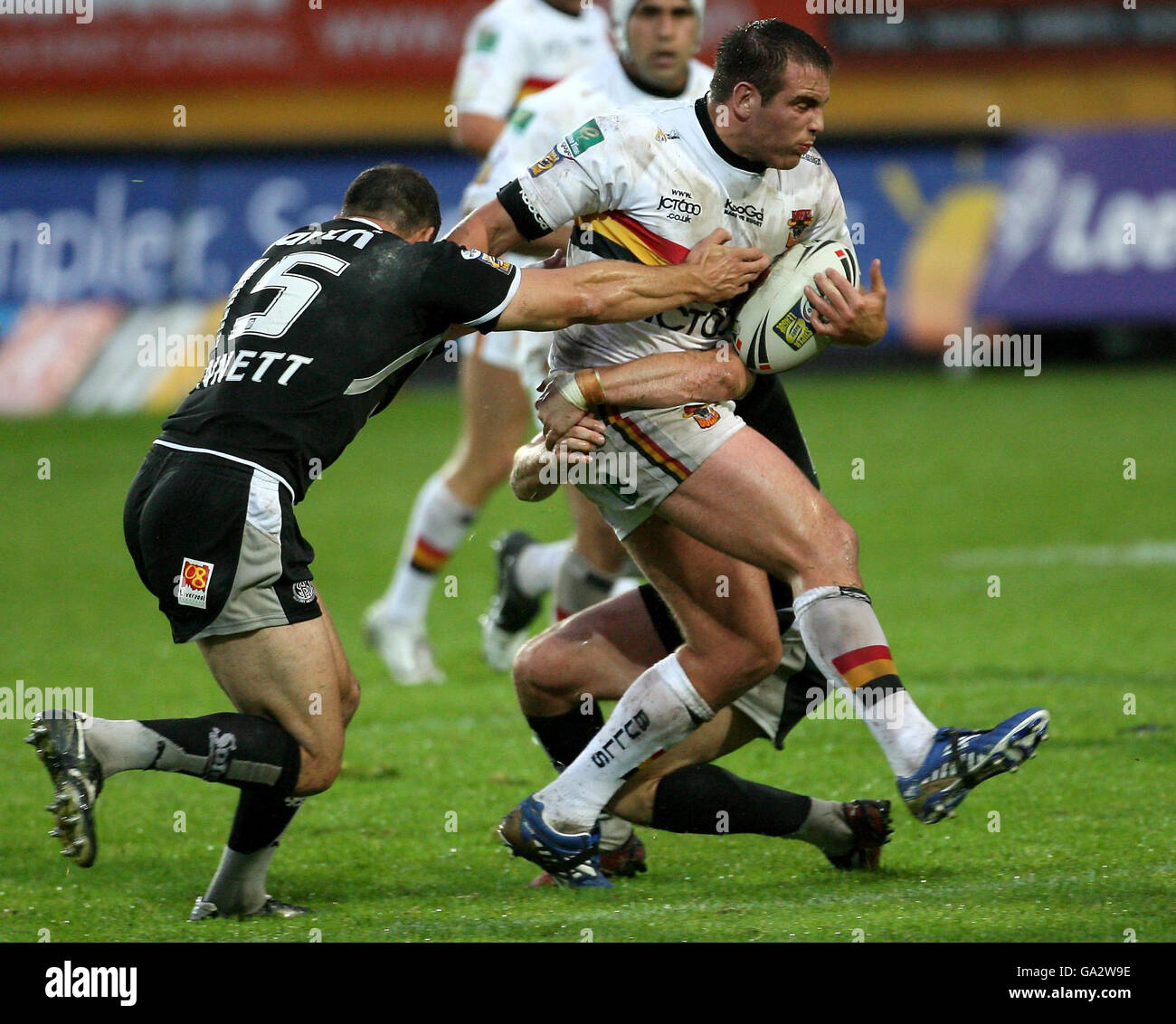 Bradford's Andy Lynch breaks the tackle of St Helens's Mike Bennett ...